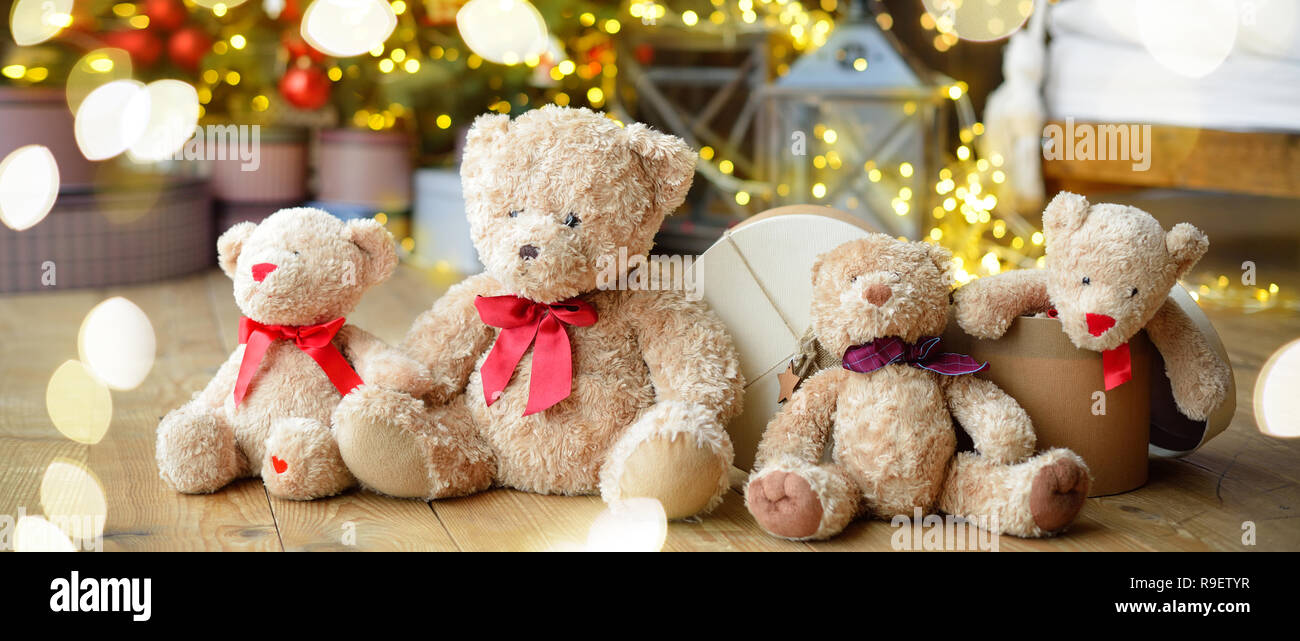 Family of teddy bears siting under the christmas tree with presents ...