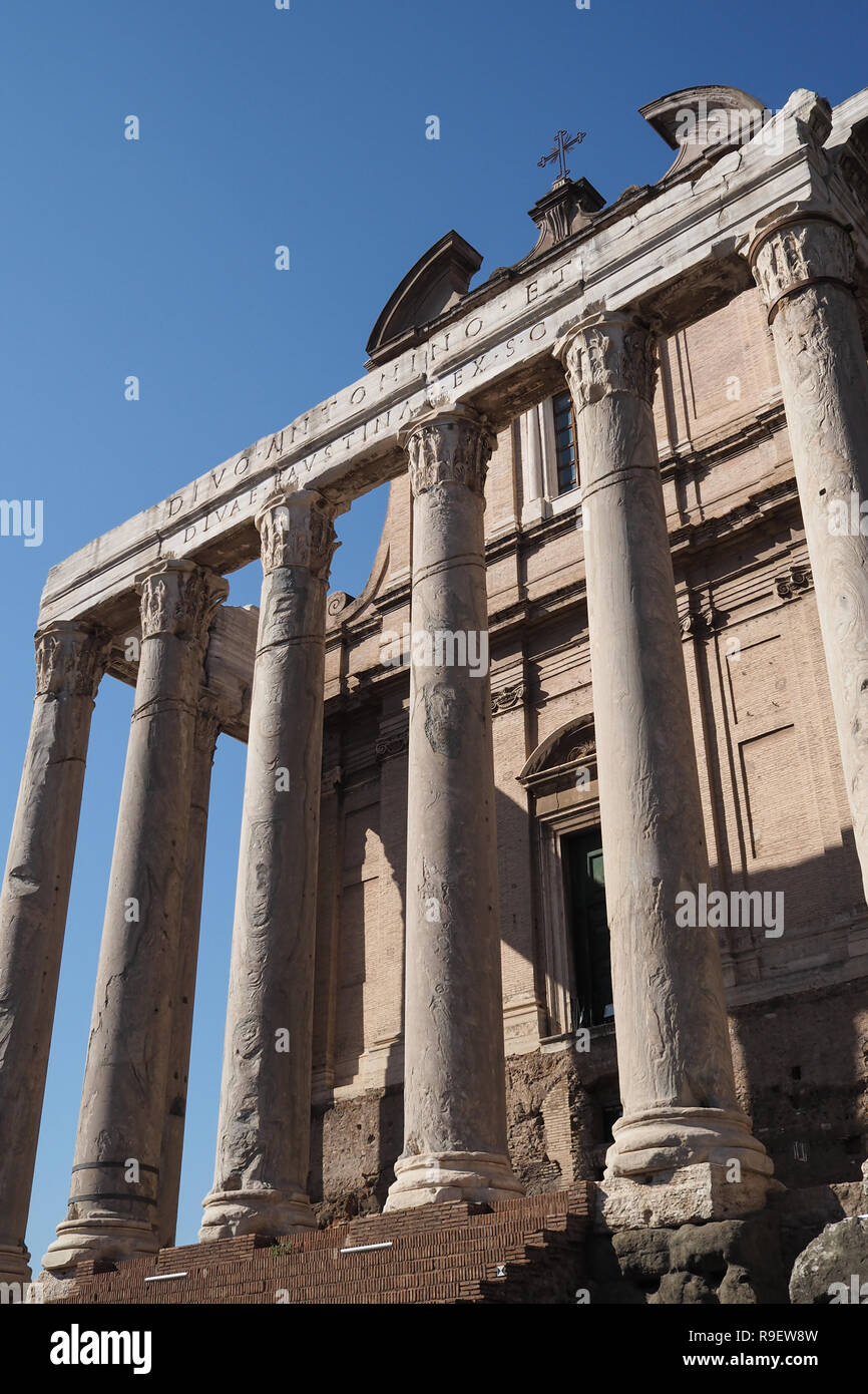 Ruins of an old stone temple with columns and latin script in the Roman ...