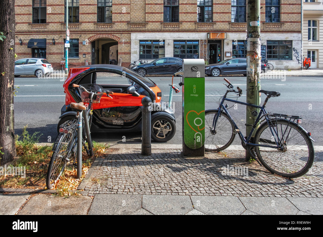 Berlin-Mitte. Renault Twizy electric car at charging point. Tiny two ...