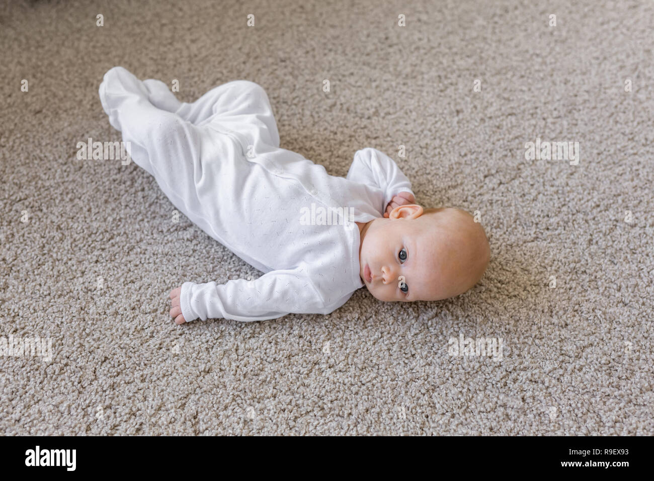 Baby, infant and childhood concept - Top view of the child on the floor ...