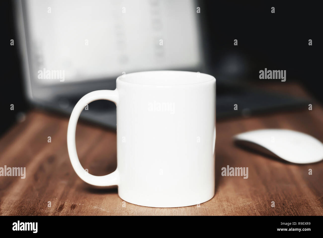 White mug on the wooden table. Office background Stock Photo - Alamy