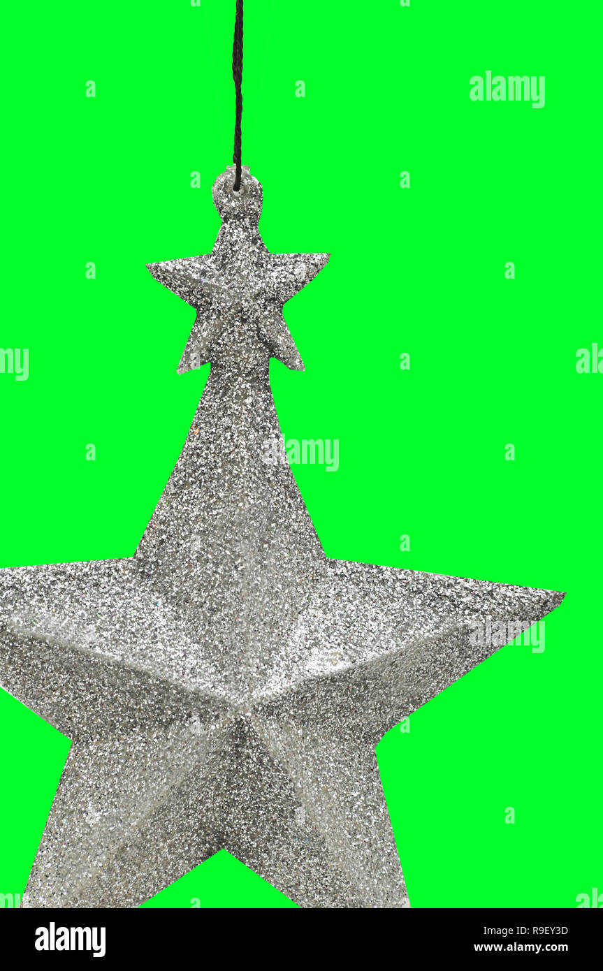 Christmas and New Year's silver five-pointed star on the green isolated ...
