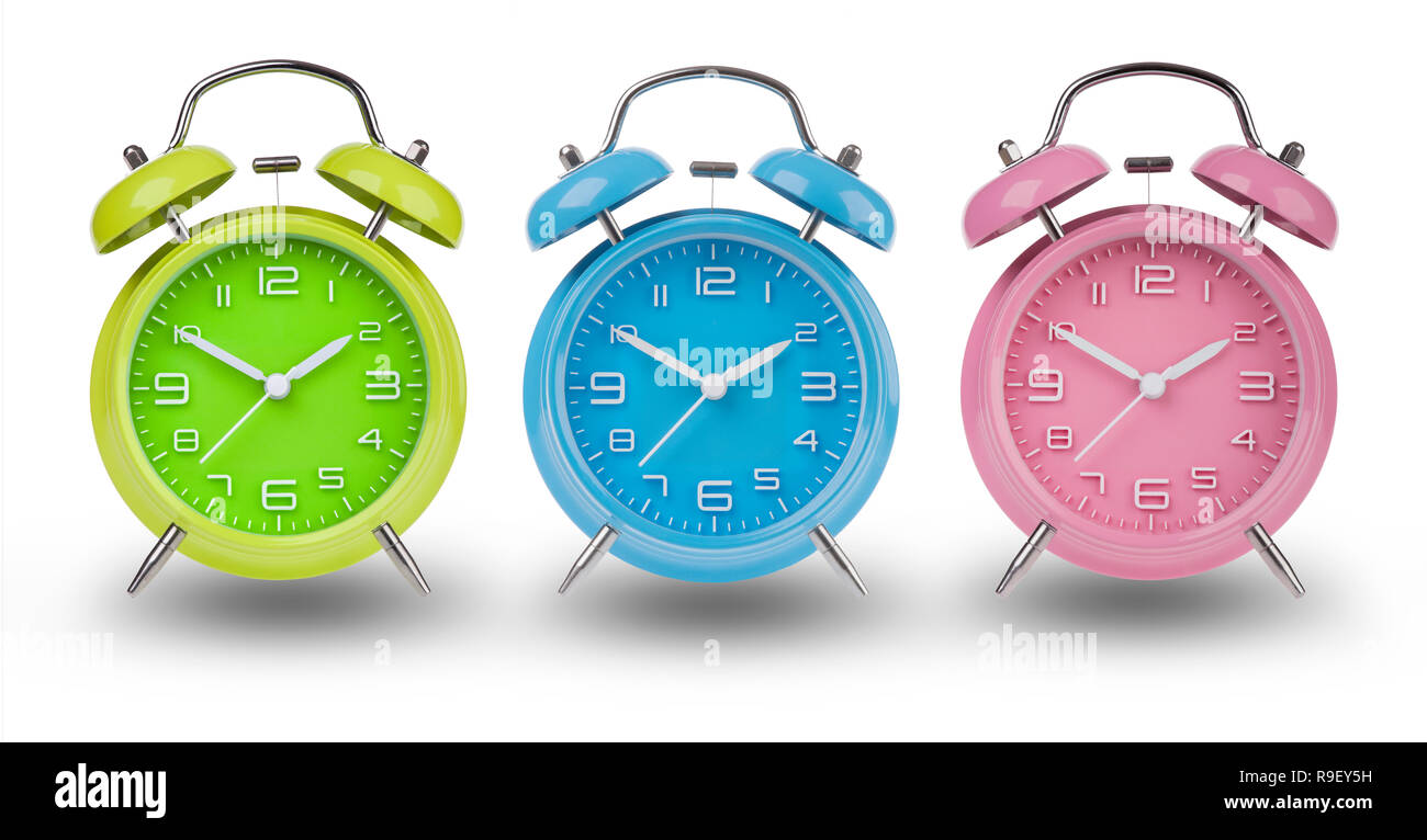 Three alarm clocks with the hands at 10 and 2 am or pm isolated on a ...