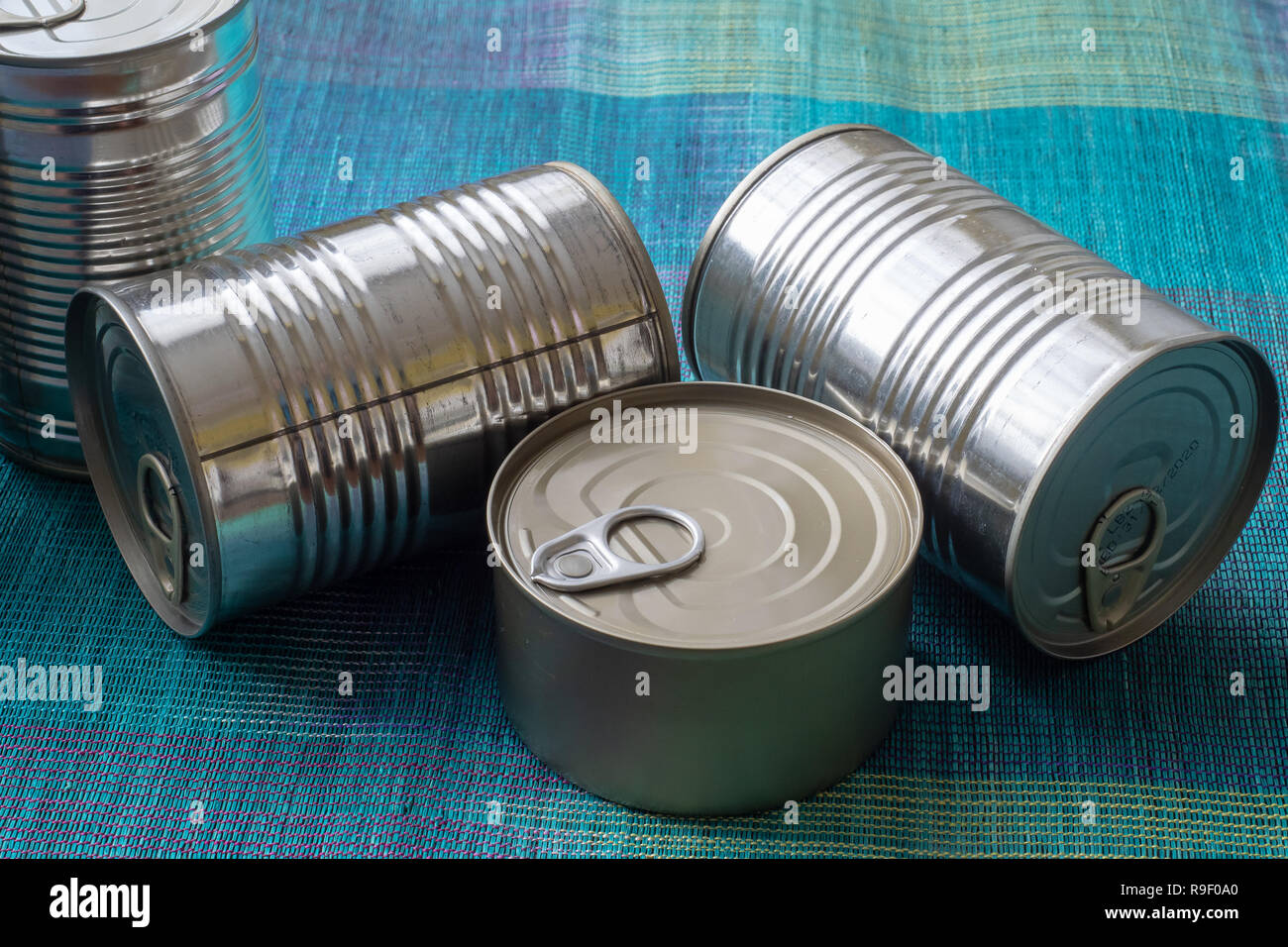 Tin cans with food. Conserved food. Closeup of a group of aluminium ...