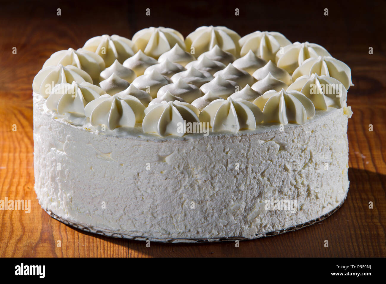 White sponge cake on a wooden background, spot light studio Stock Photo ...