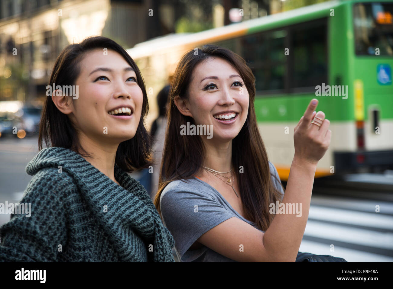 Two Girlfriends Meeting Outdoors And Having Fun Japanese People