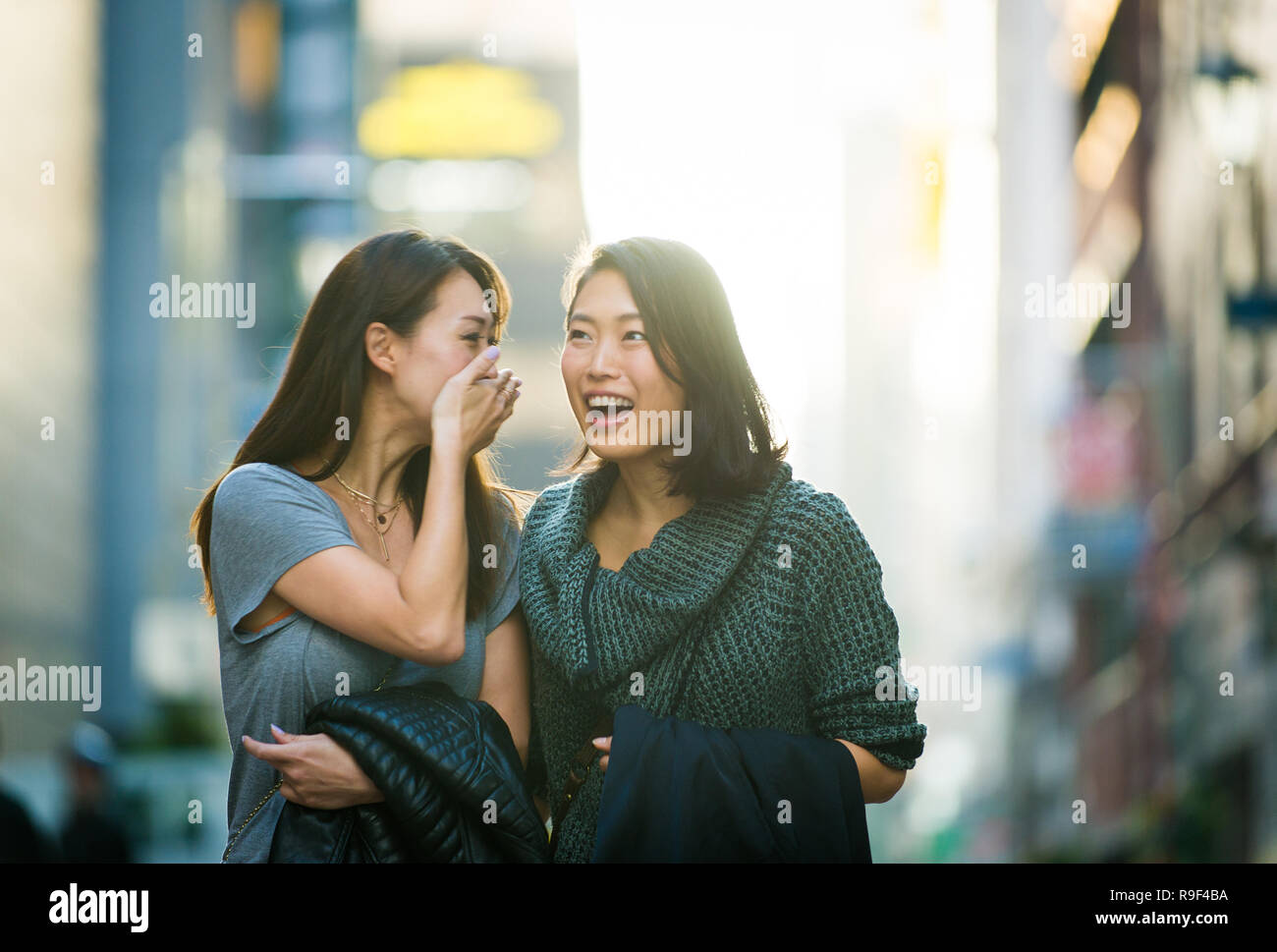 Two girlfriends meeting outdoors and having fun - Japanese people ...
