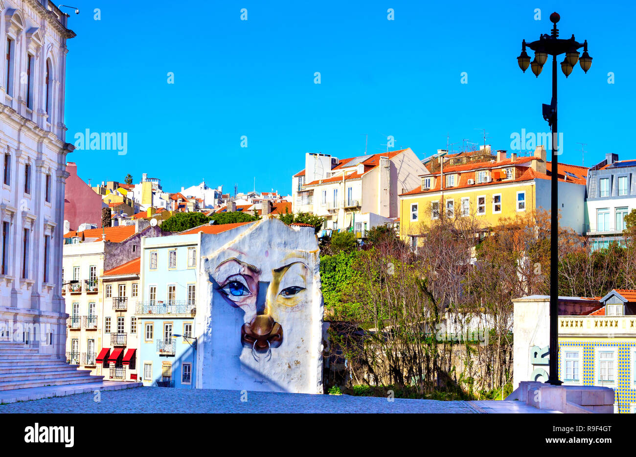 Beautiful Lisbon scenery with red roofs and graffitis on the walls ...
