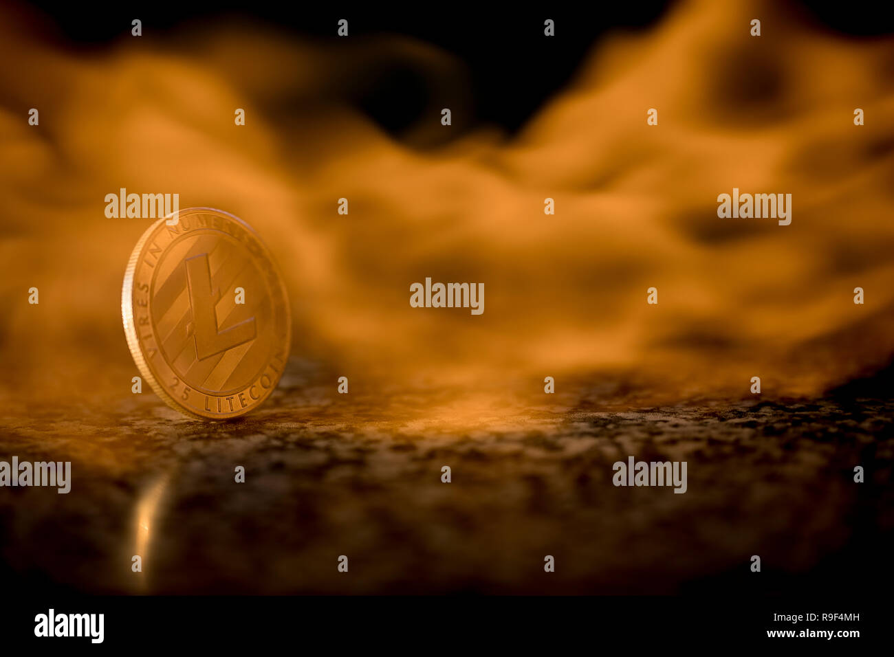 Litecoin cryptocurrency coin blown away with fire flames Stock Photo ...