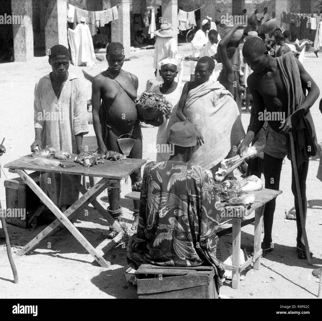 Native man selling meat at street market in Nigeria 1959 butcher ...
