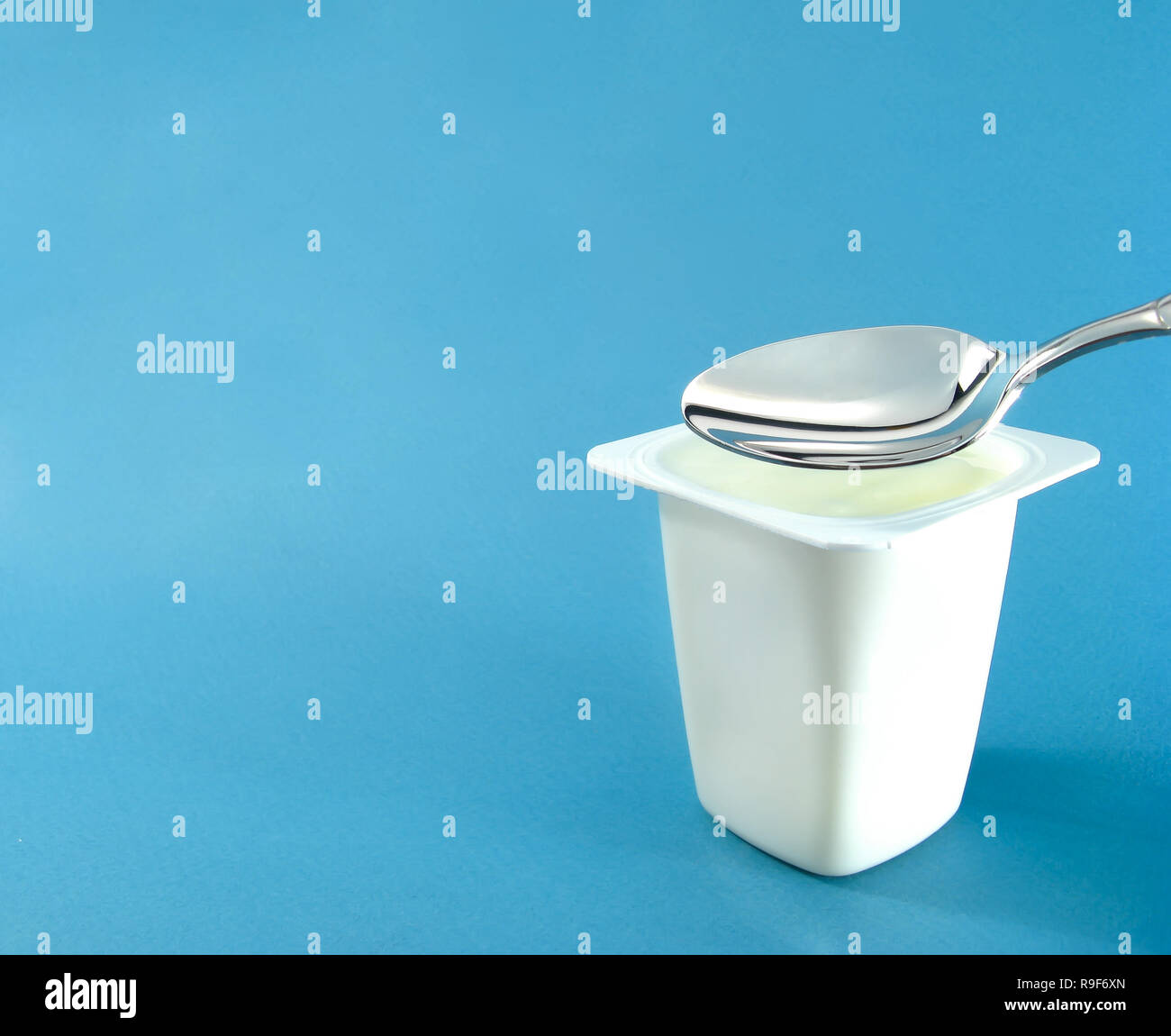 dairy and rustic farm food styled concept - natural yogurt on blue ...