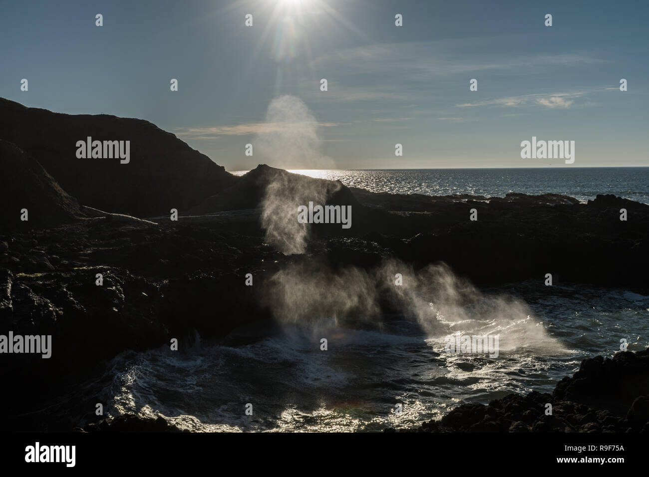 Backlight of the water expelled by a hole in the rock when the waves ...