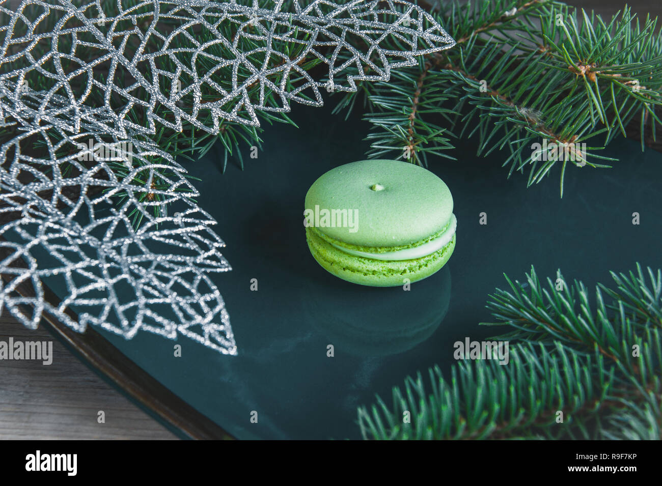 Fresh red macaroons at the Christmas table with the garland on the ...