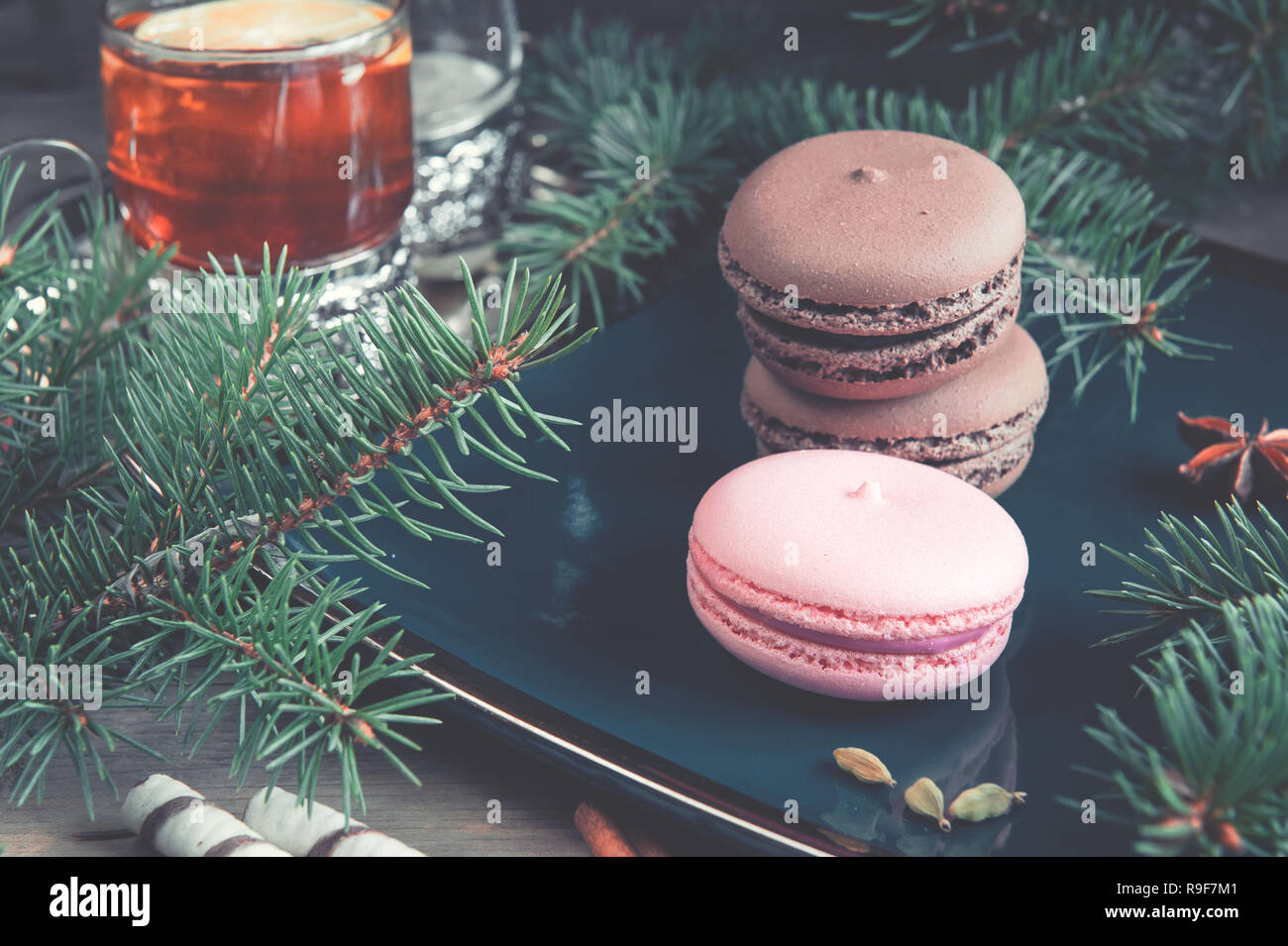 Fresh red macaroons at the Christmas table with the garland on the ...