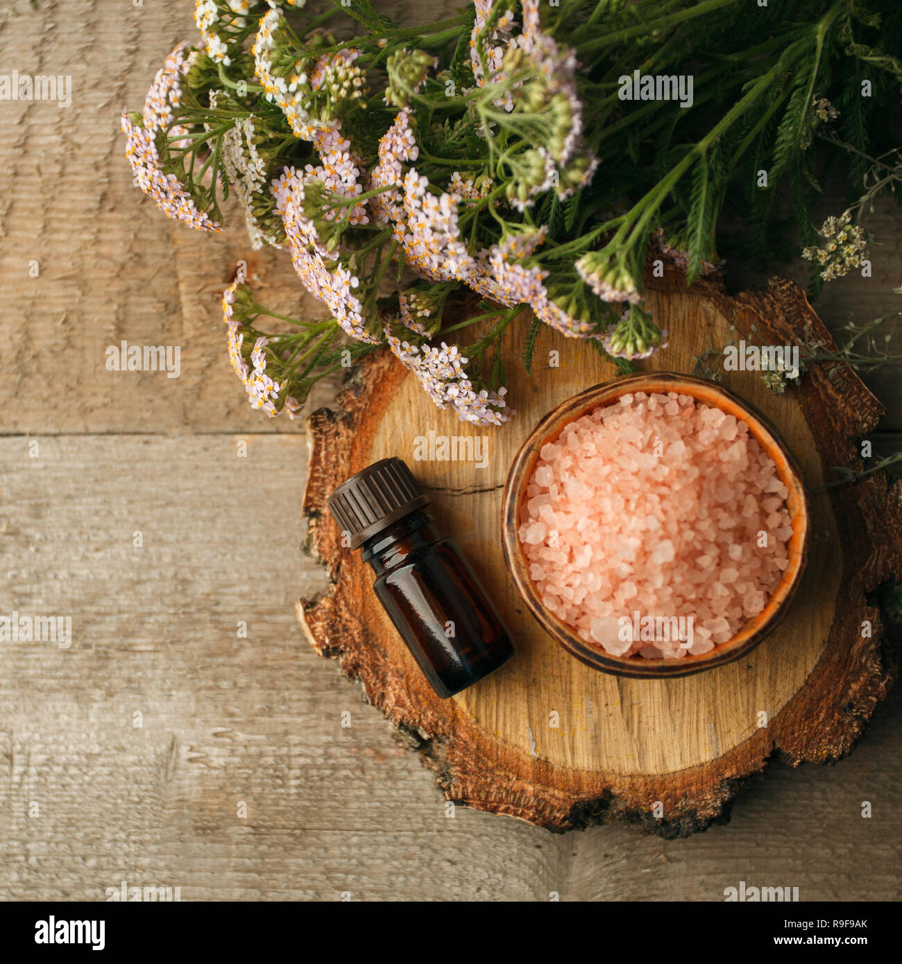 Spa and wellness setting with sea salt, oil essence, cones and candle ...