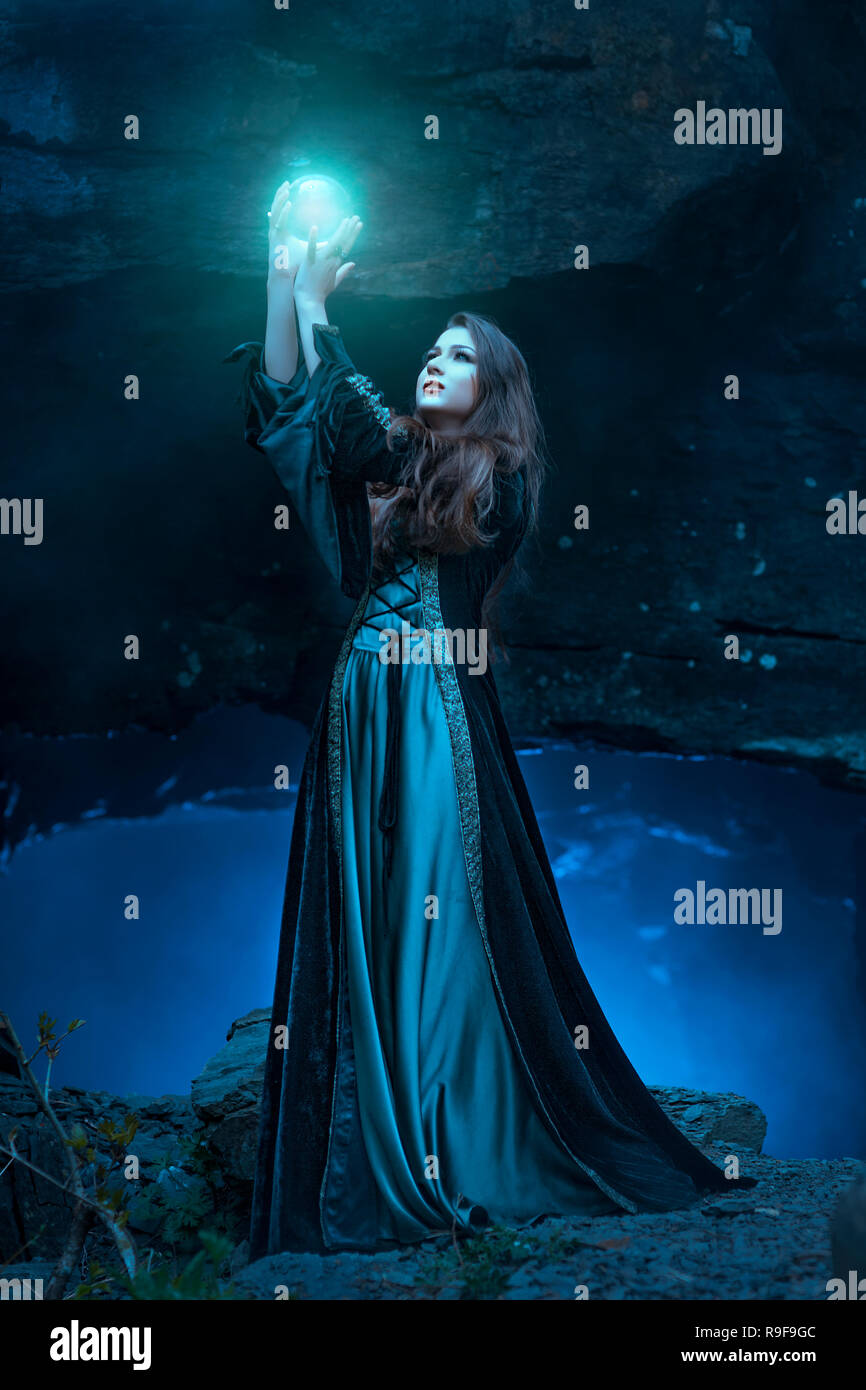The witch with magic ball in her hands causes a spirits Stock Photo - Alamy