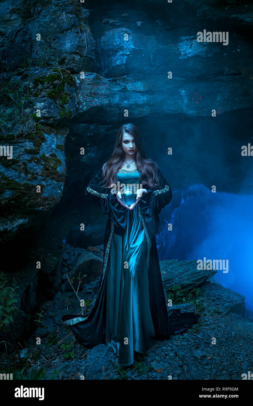 The witch with magic ball in her hands causes a spirits Stock Photo - Alamy