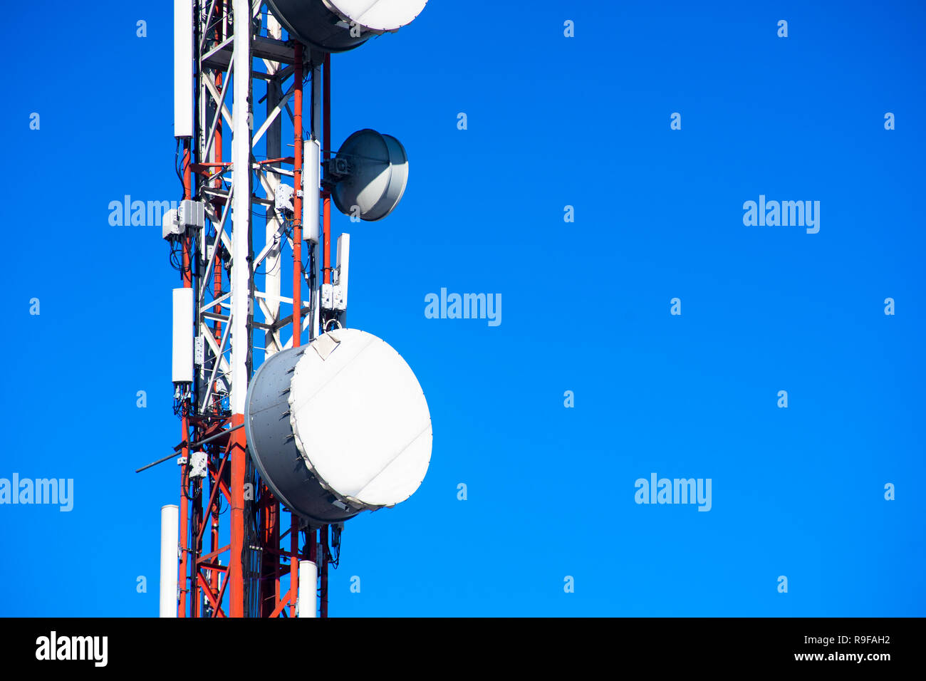 Mobile phone communication tower transmission signal with blue sky ...
