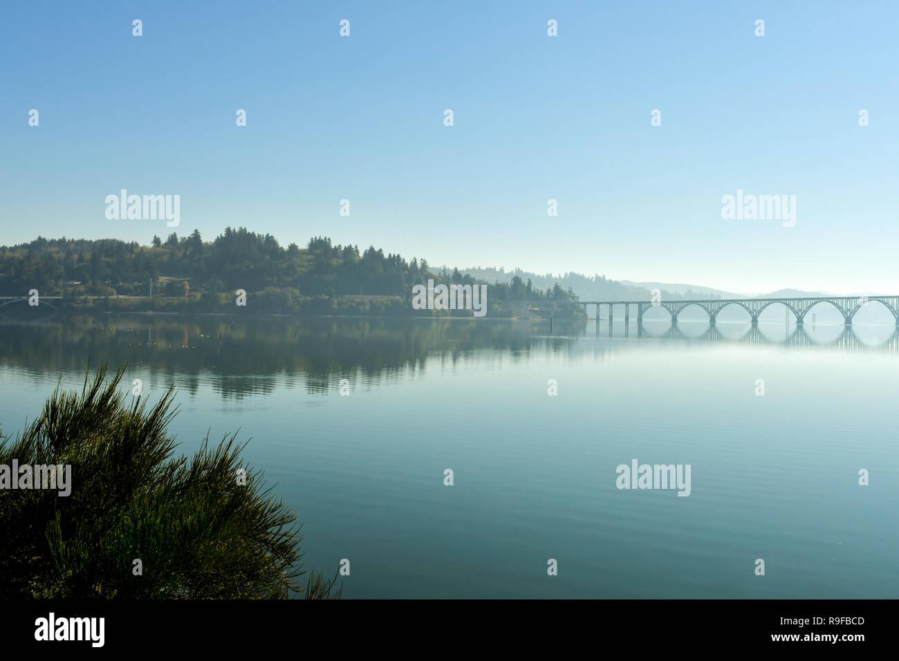 Views of a bridge over the Coos River bay at its mouth next to the ...