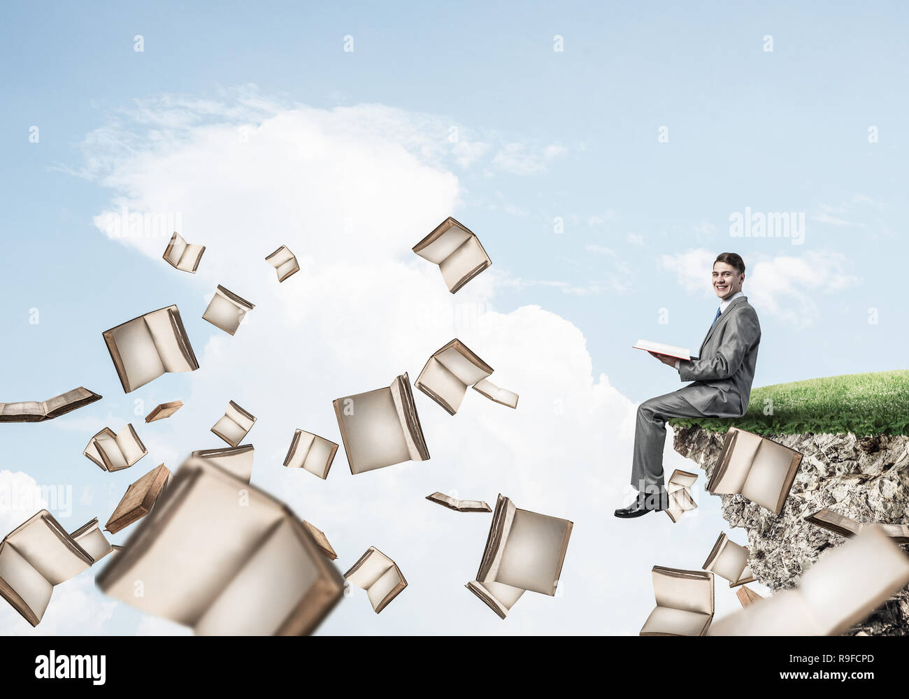 Man reading book and many of them flying in air Stock Photo - Alamy