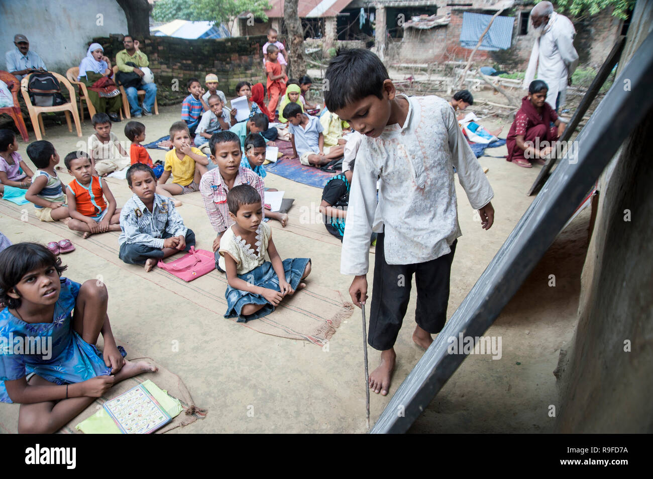 Varanasi / India 20 September 2011 Student teaching on blackboard in ...
