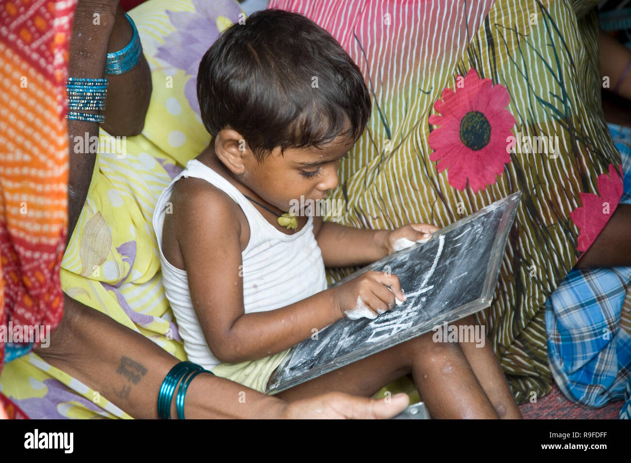 Varanasi / India 20 September 2011 Little village boy studying with his ...