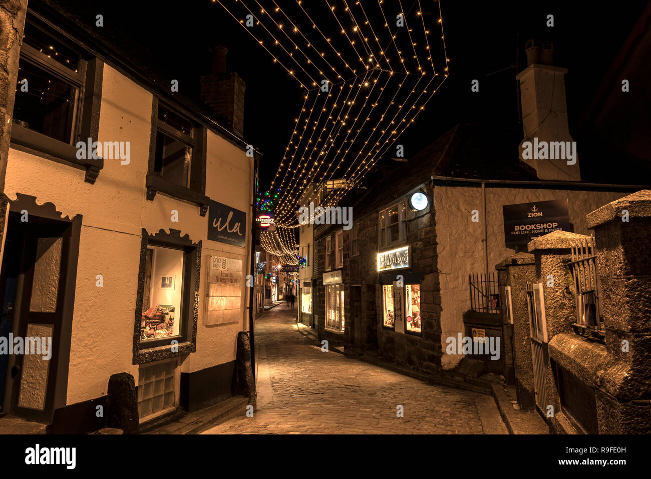Christmas lights above the cobbled streets of St.ives in Cornwall with ...