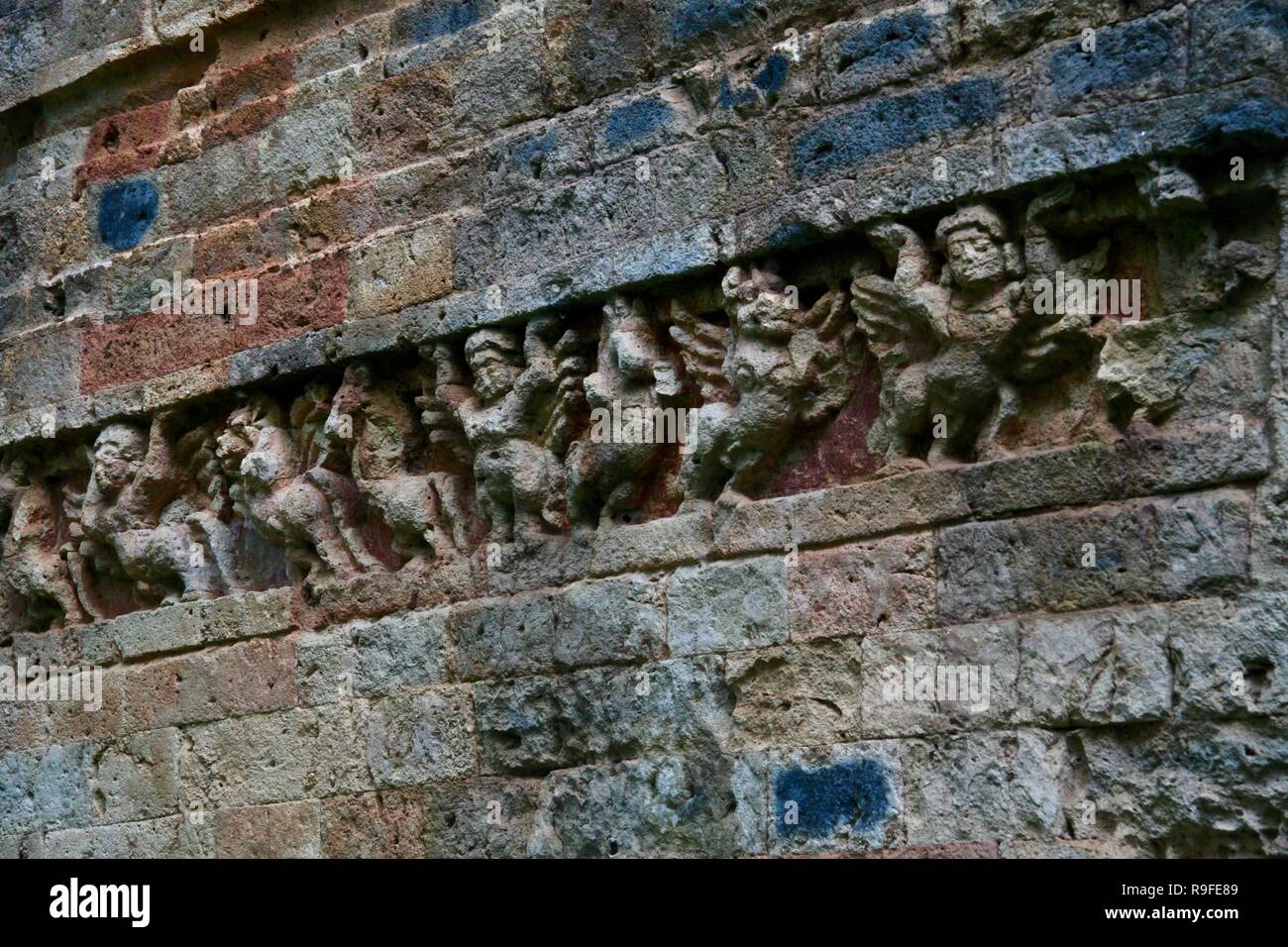 Dancing angels and horses carved into a brick wall Stock Photo - Alamy