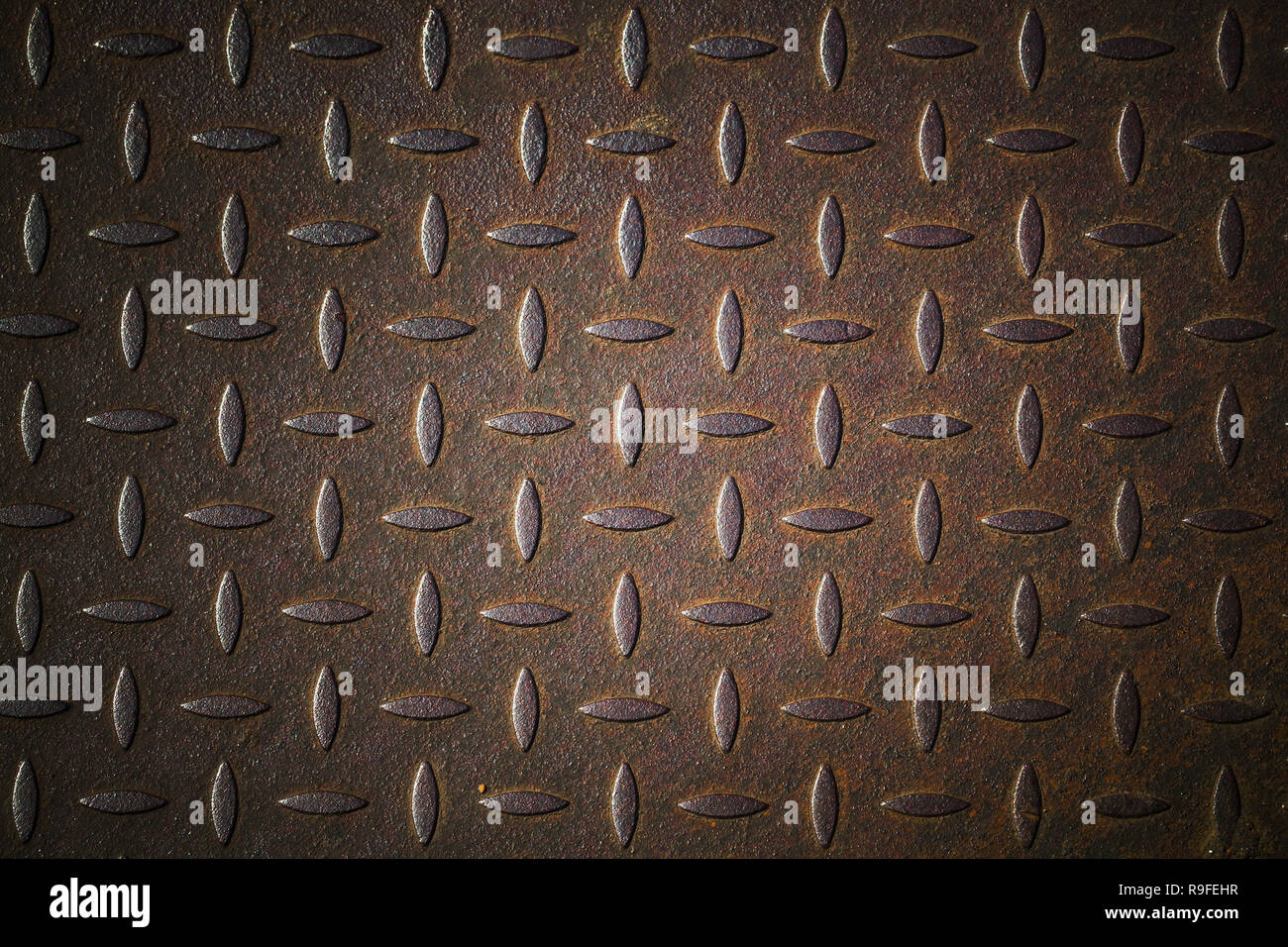Dark rusted diamond plate metal wall pattern. Background photo texture ...