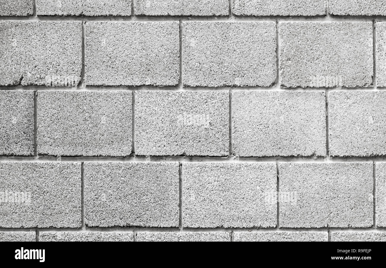 Stone wall made of gray foam concrete blocks, background photo texture ...