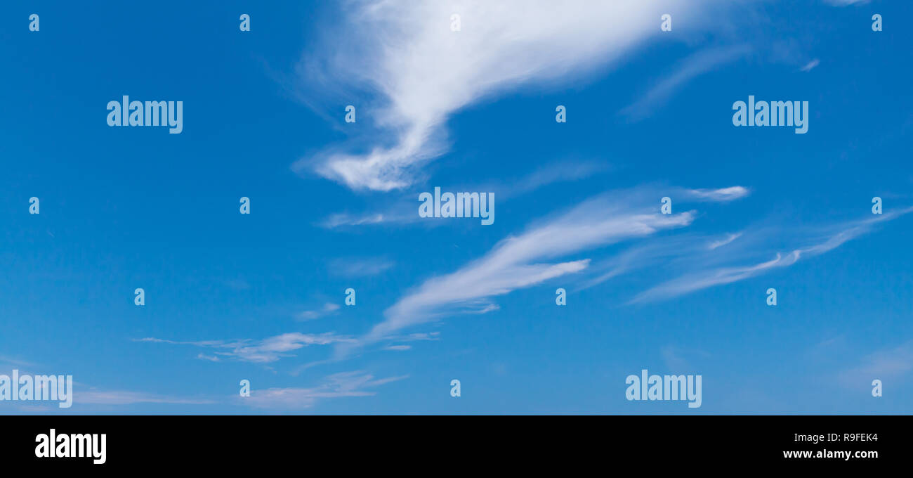 Blue sky with windy cirrus clouds at daytime. Natural panoramic ...
