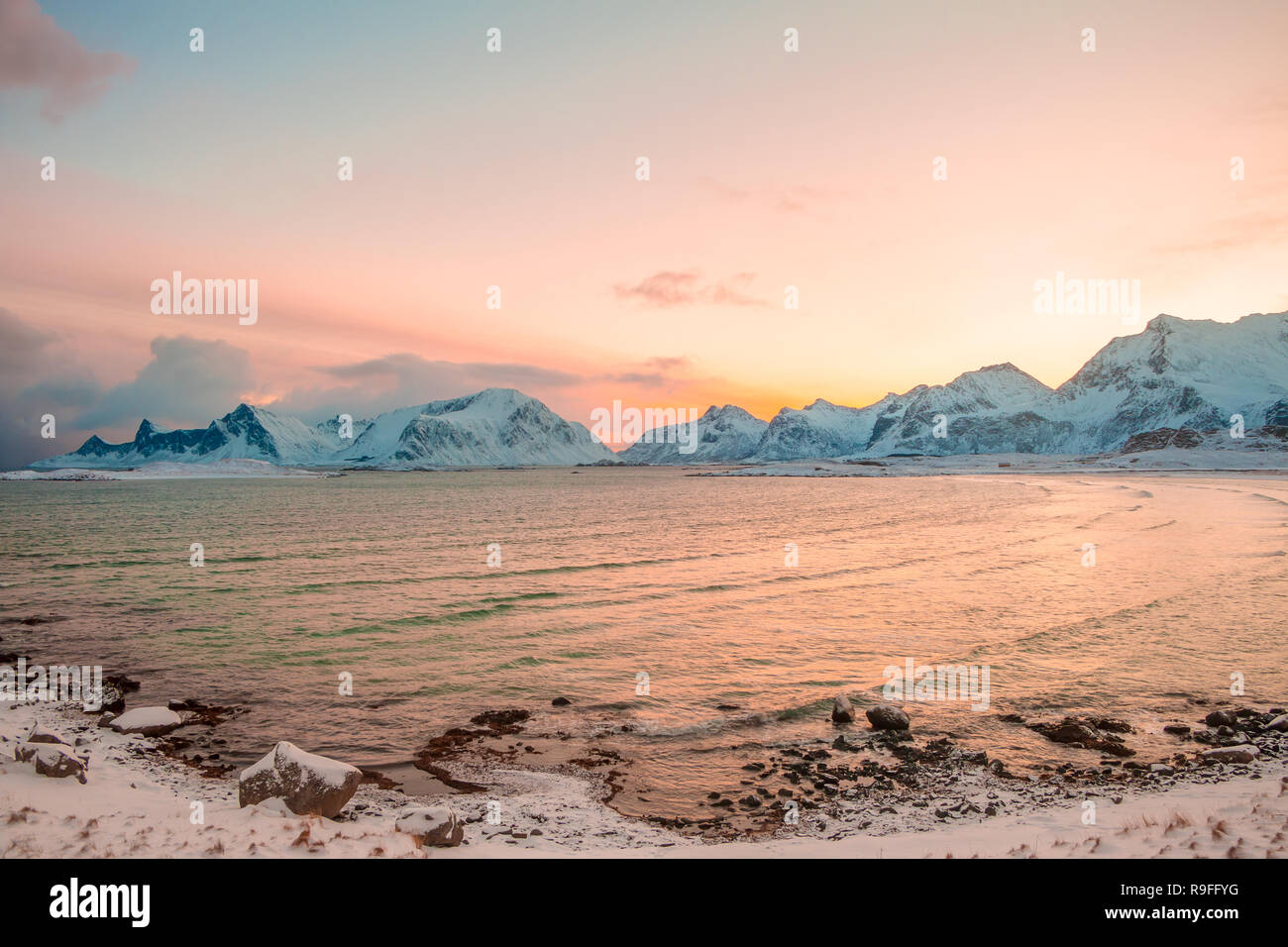 Winter. Norwegian fjord surrounded by snow-capped mountains in the ...
