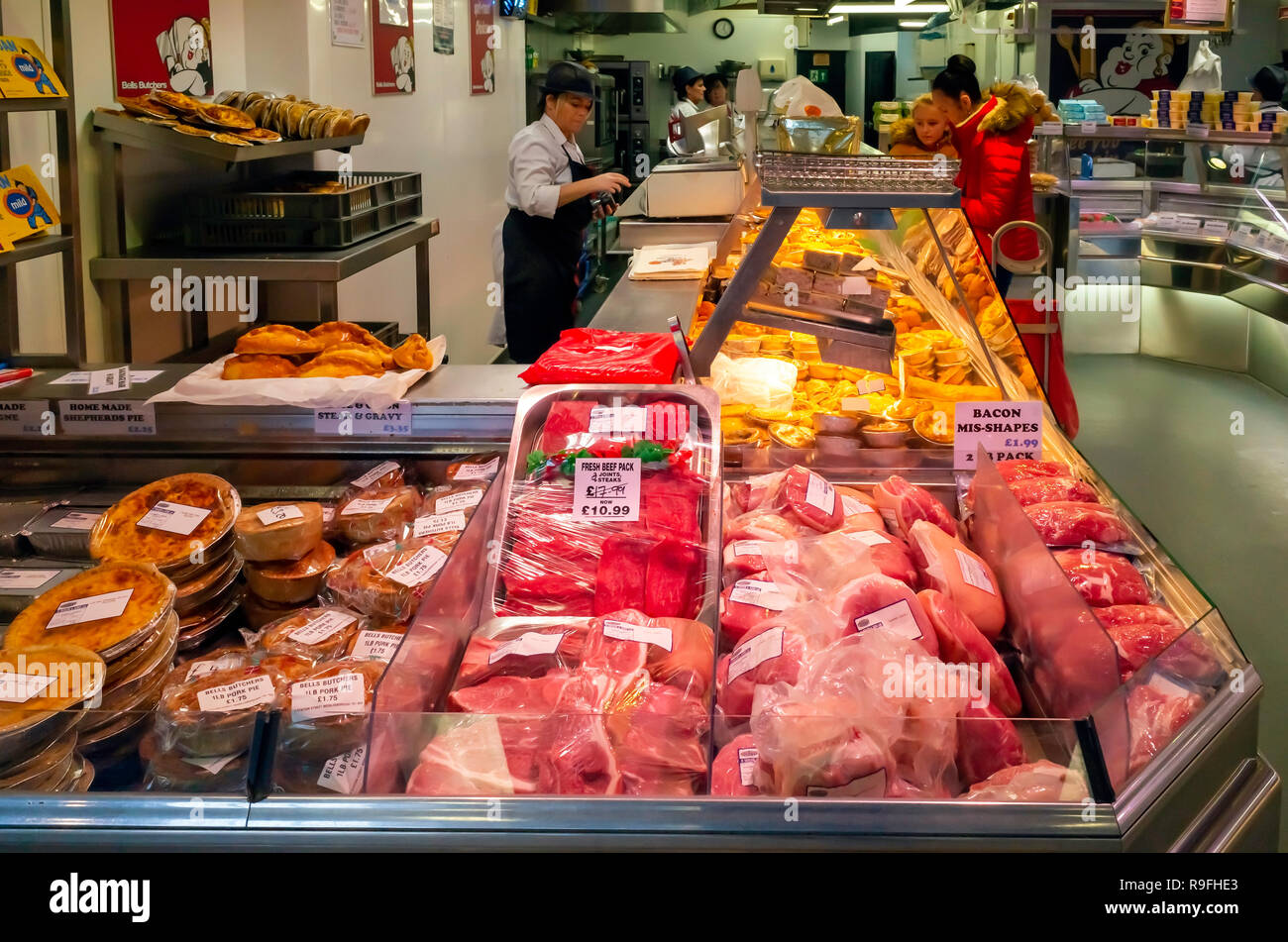 A woman and child shopping in Bell's Butchers, established 1927 and ...