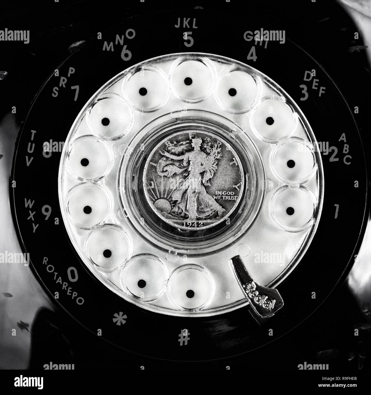 Vintage rotary phone dial with old silver coin Stock Photo - Alamy