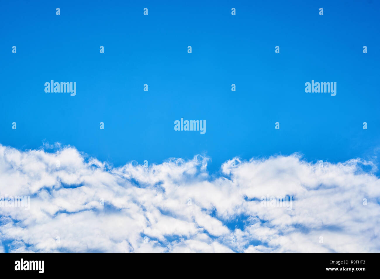 Saturated blue sky with clouds below Stock Photo - Alamy