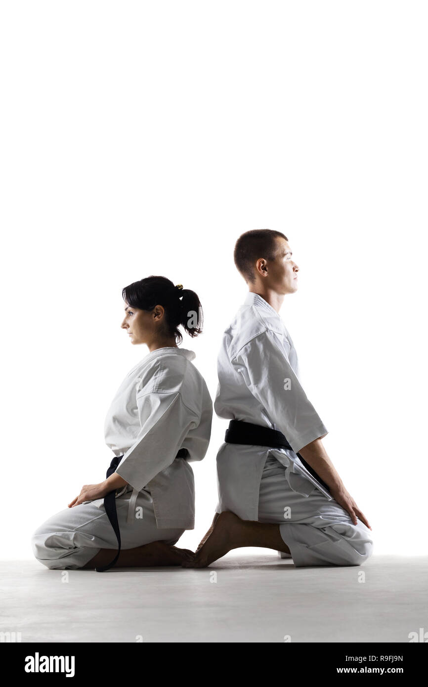 karate girl and boy sitting against white background Stock Photo - Alamy