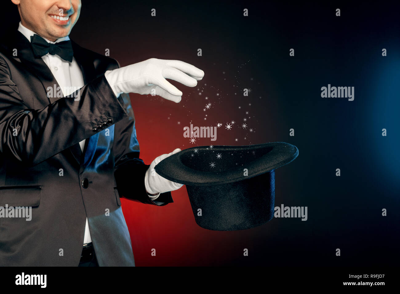 Professional showman wearing suit and gloves standing isolated on black ...