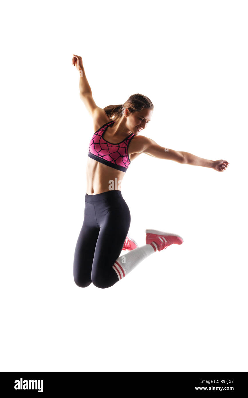 fit runner girl jumping with happy expression against white background ...