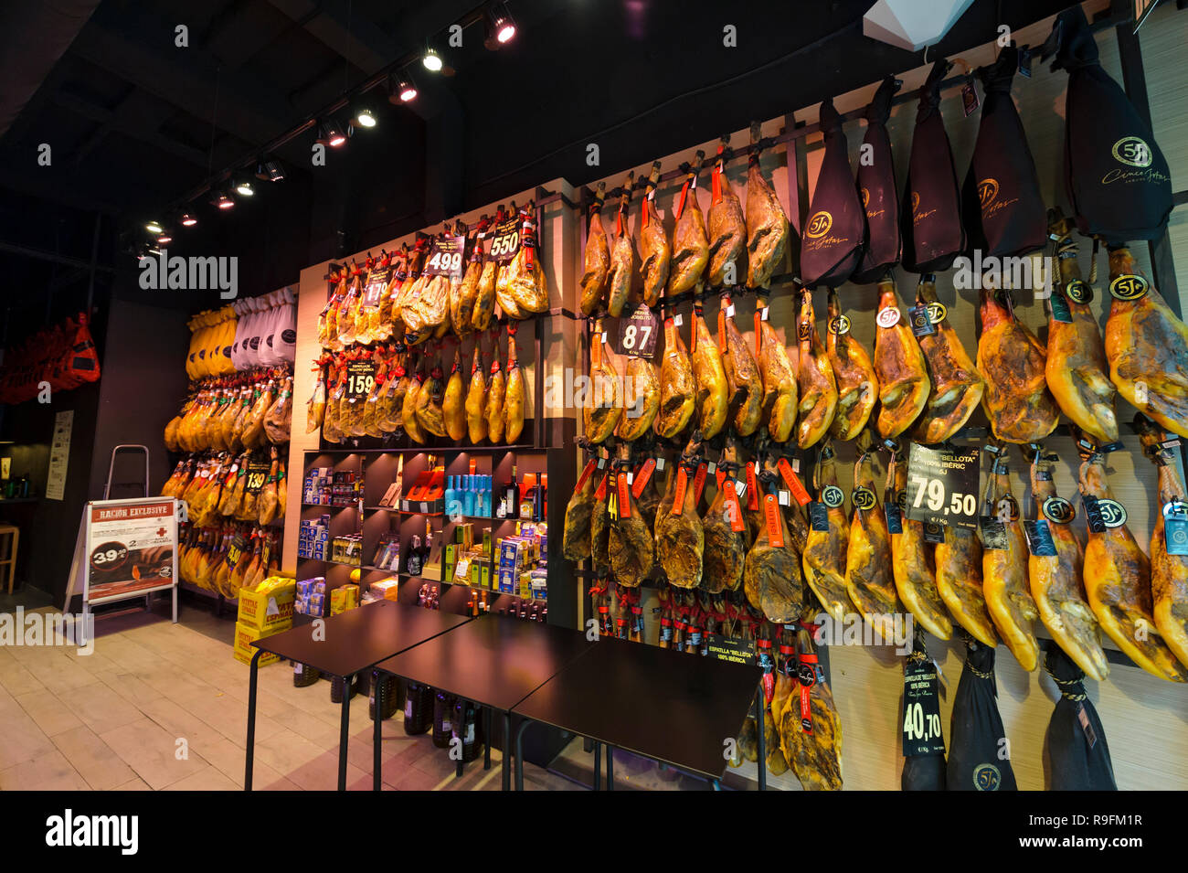 A display of hanging Jamon for sale in a shop in Barcelona, Spain Stock ...