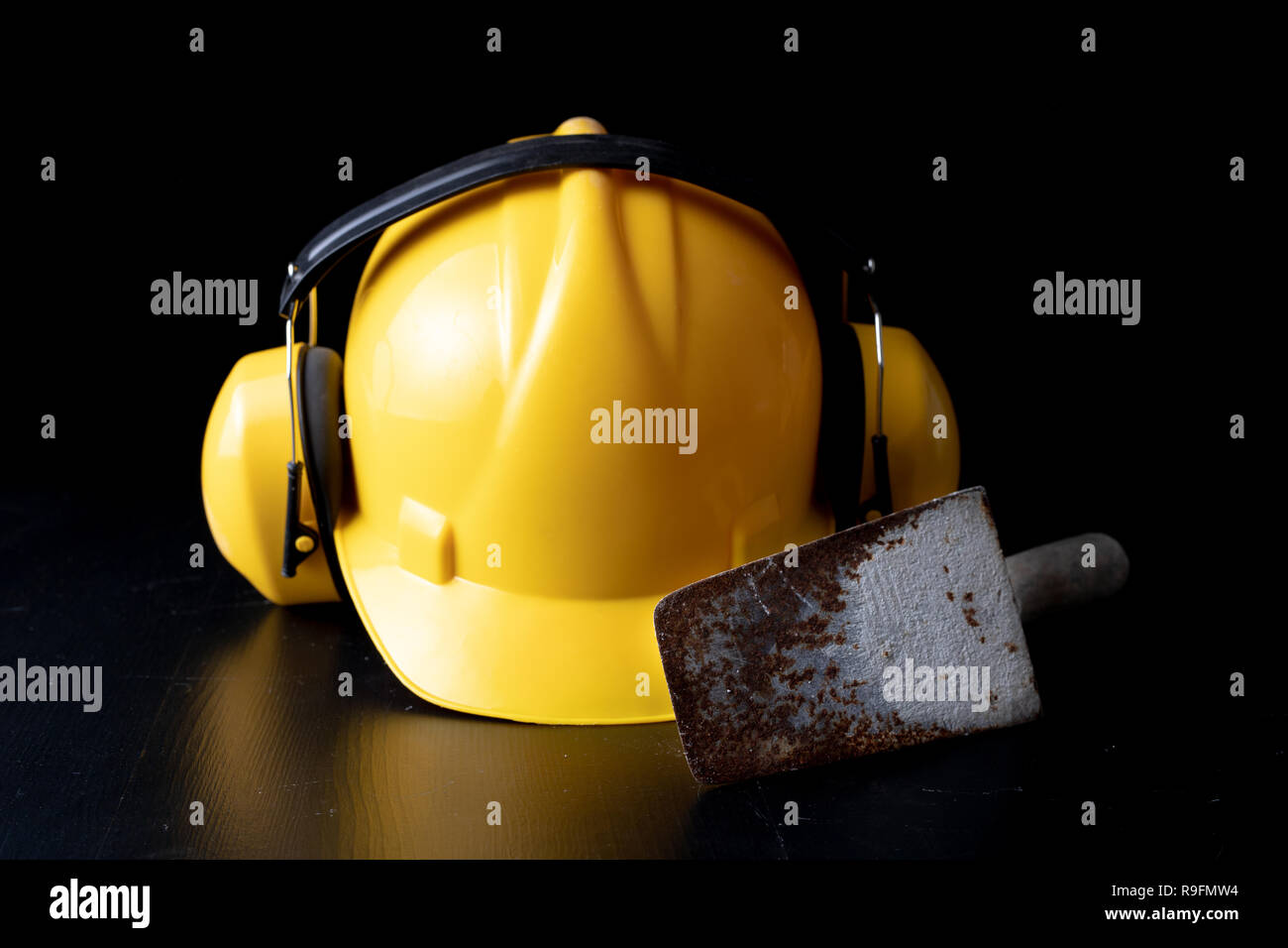 Tools for bricklayer and helmet on a black table. Accessories for ...