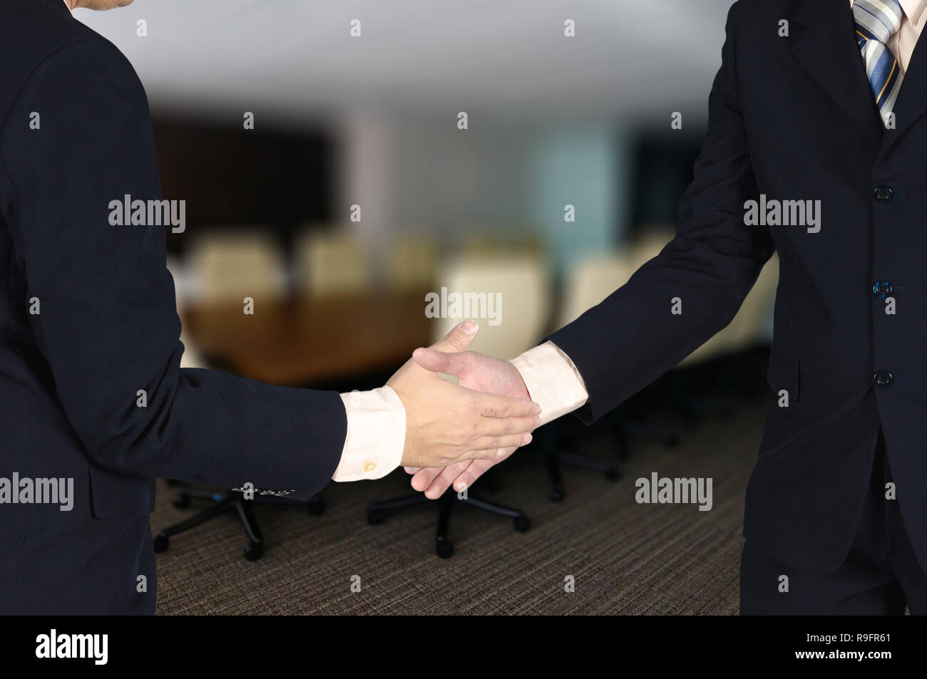Double exposure of confident Asian businessman shaking hand in meeting ...