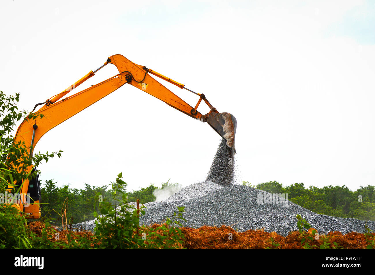 backhoe loader working on pile stone mound / Large heavy duty digger at ...