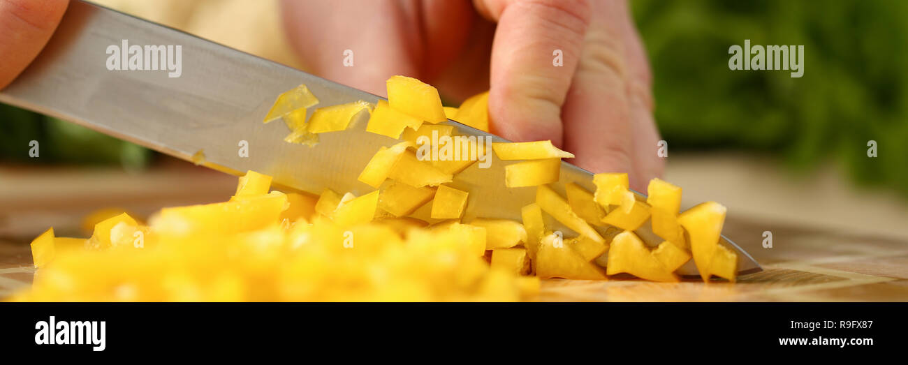 Cook holds knife in hand and cuts on Stock Photo - Alamy