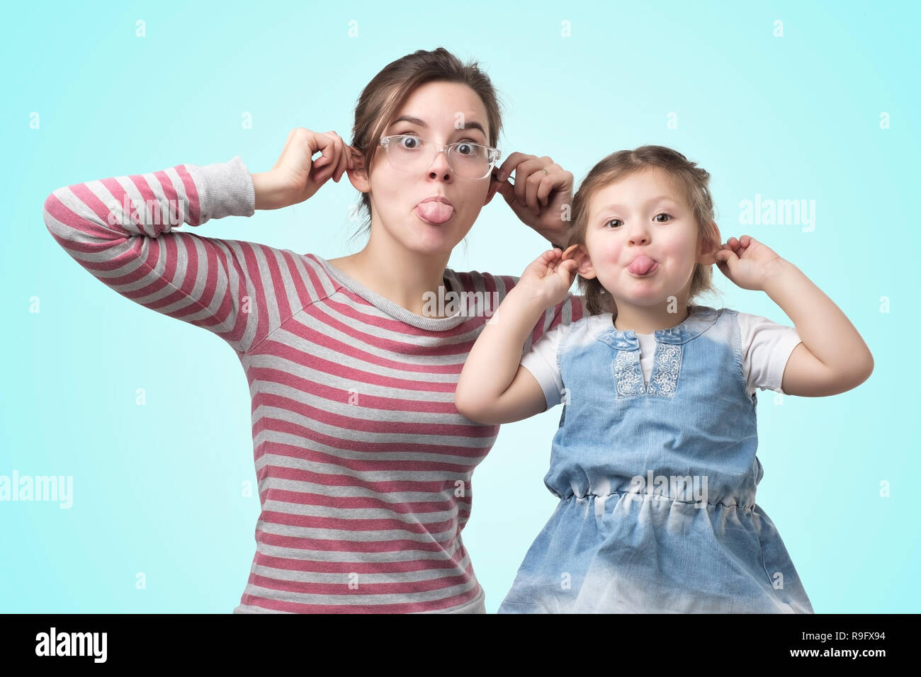 Mother and her daughter girl showing monkey grimace Stock Photo - Alamy
