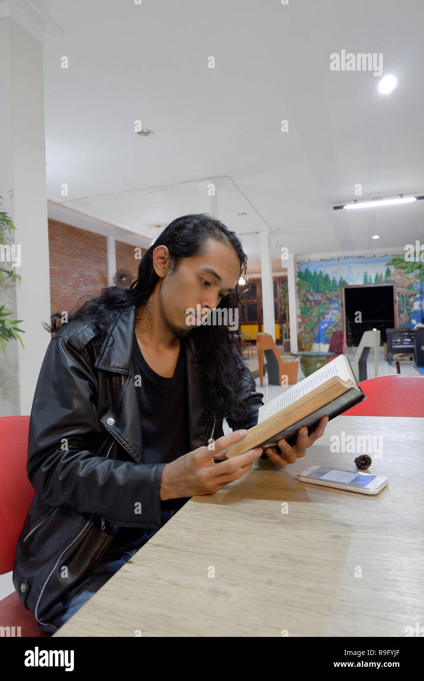 man reading a book in library Stock Photo - Alamy