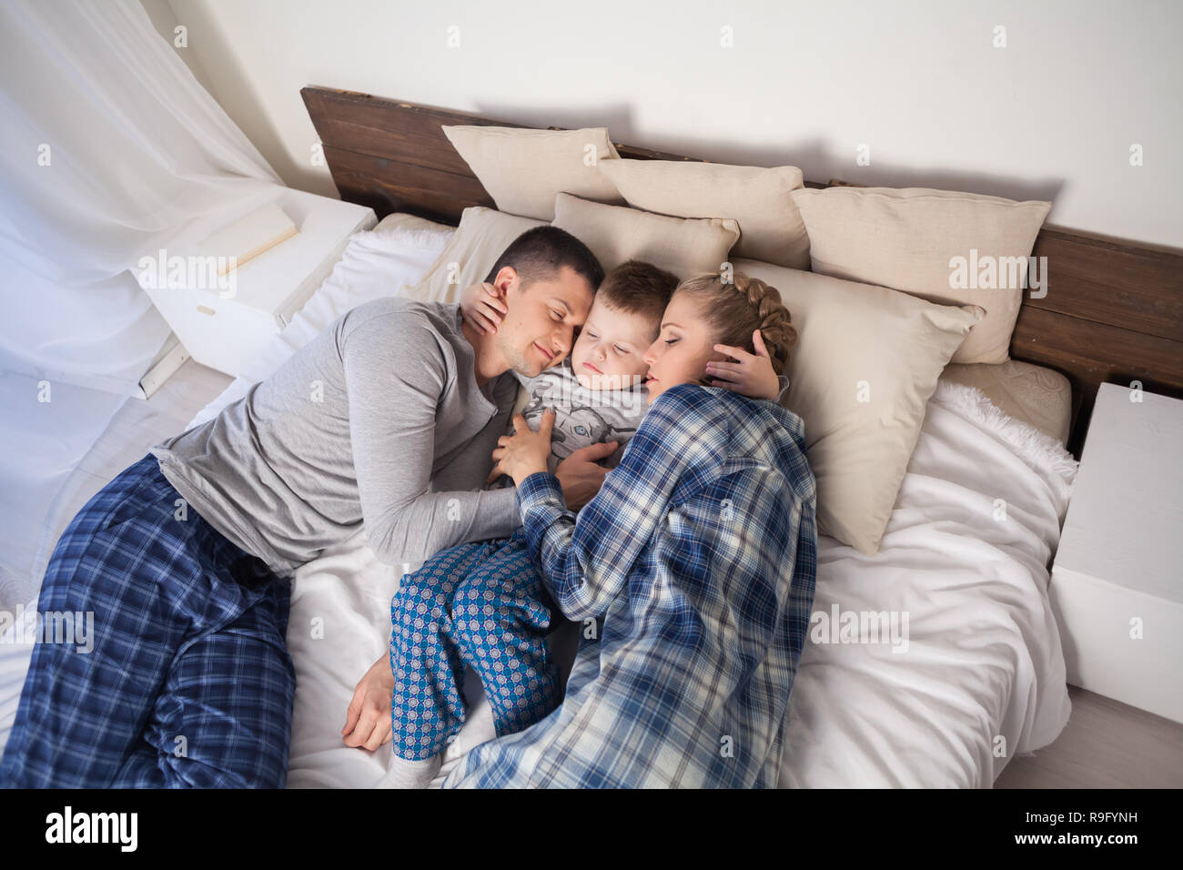Mom Dad And Young Son In The Morning In The Bedroom Mood Weekend Stock