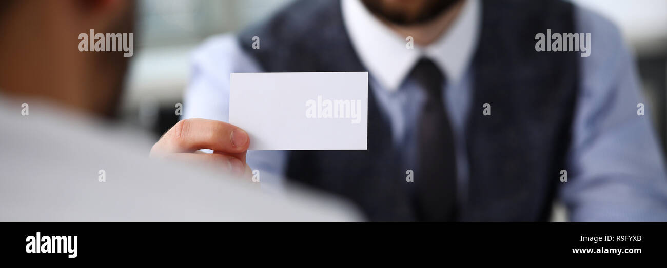 Male arm in suit give blank calling card to visitor Stock Photo - Alamy