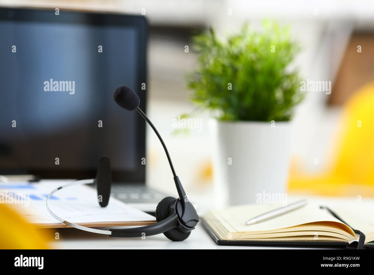 Empty remote office workplace with laptop and headset Stock Photo - Alamy