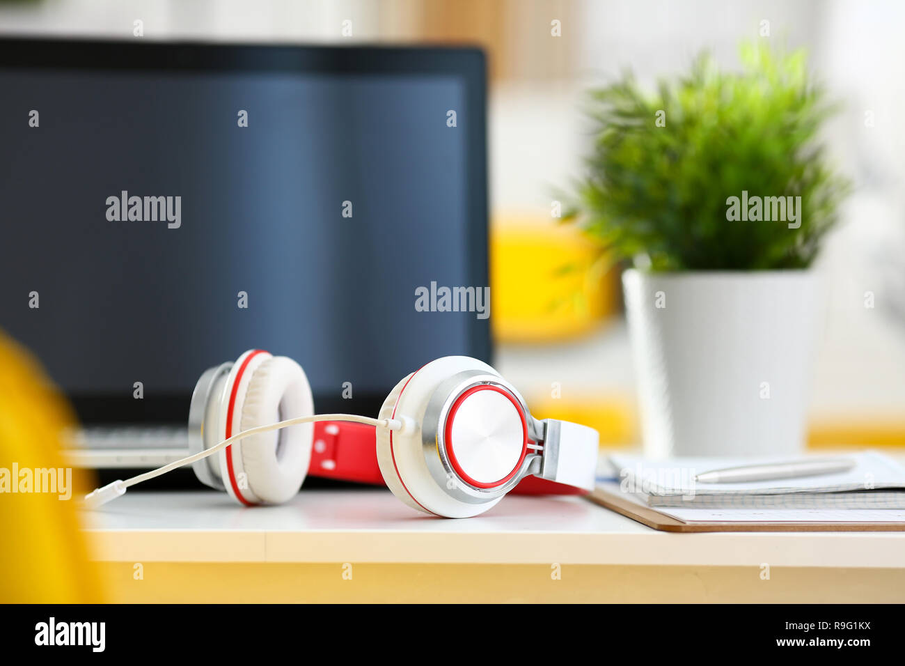 Empty remote office workplace with laptop and headset Stock Photo - Alamy