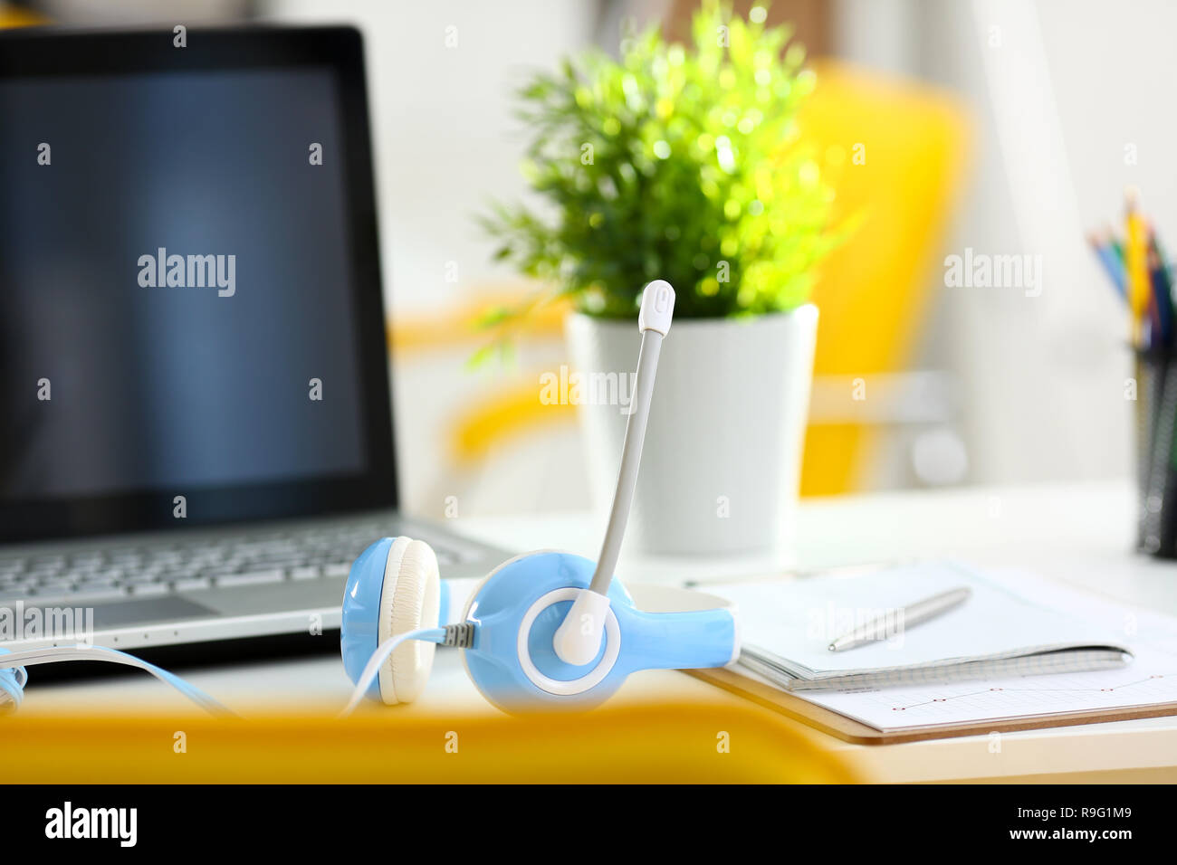 Empty remote office workplace with laptop and headset Stock Photo - Alamy